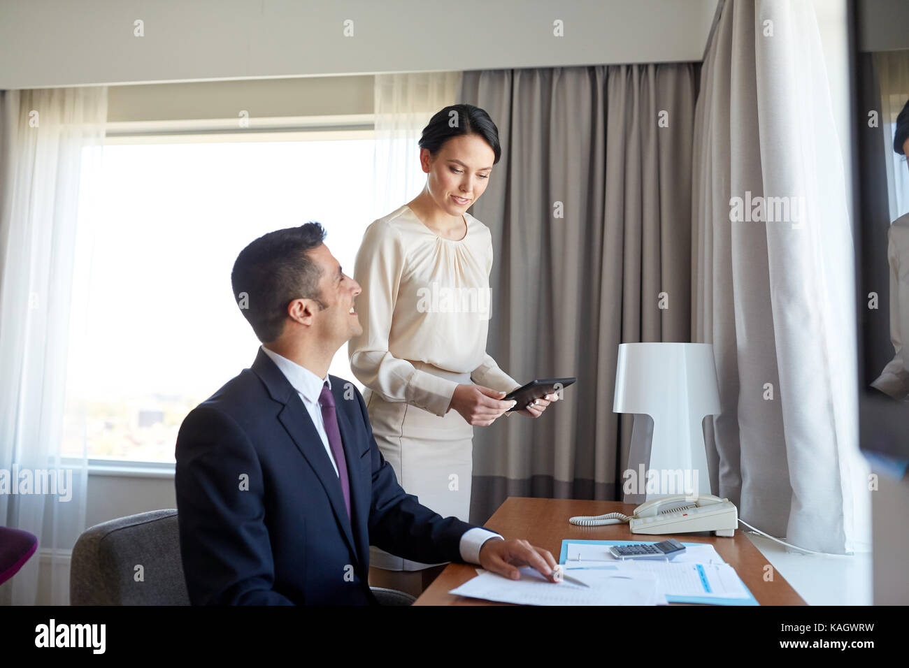 business team with papers working at hotel room Stock Photo - Alamy