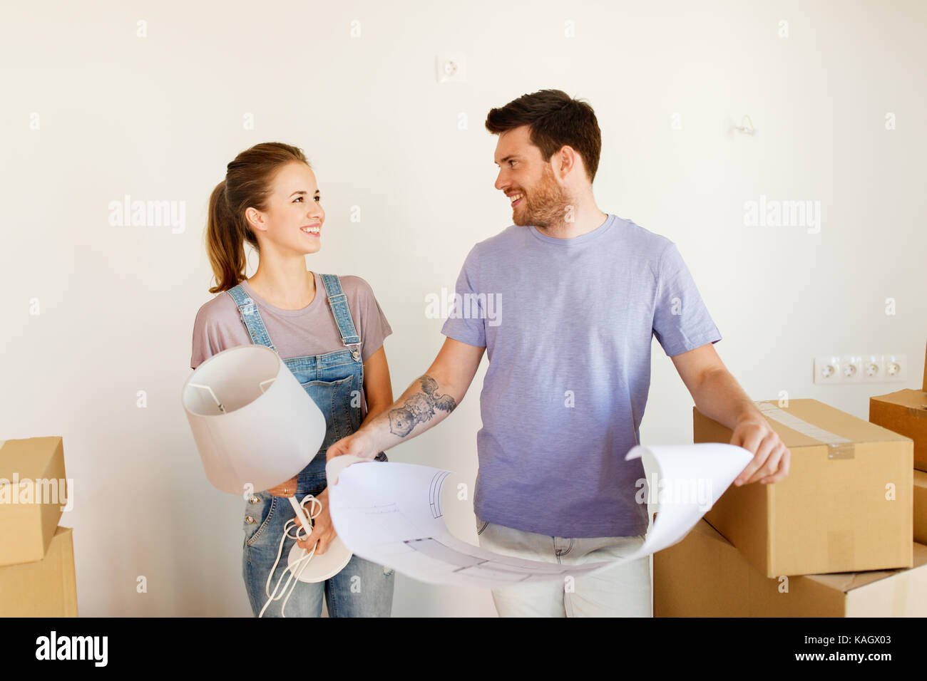 couple with boxes and blueprint moving to new home Stock Photo - Alamy