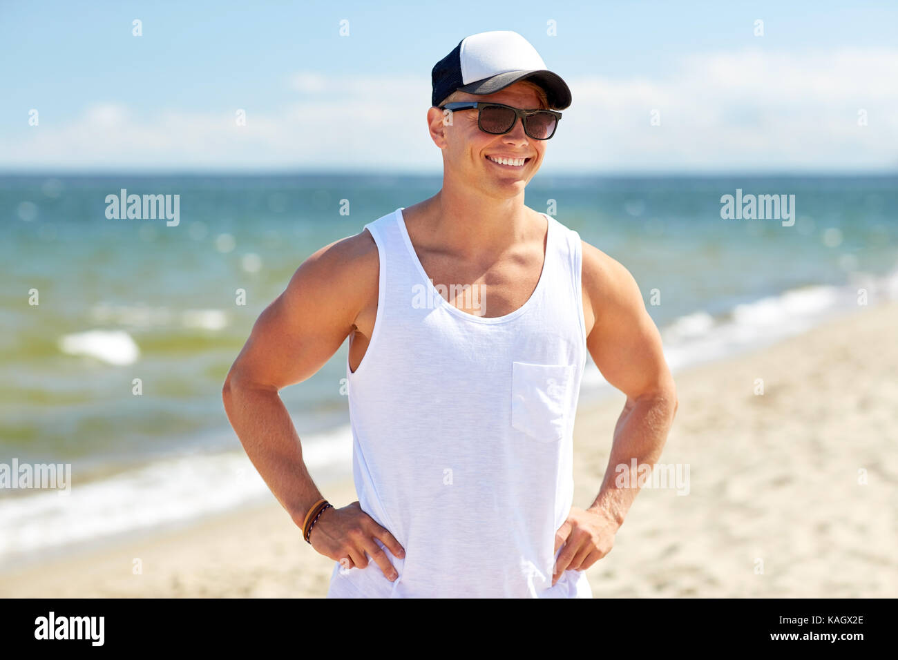 Man on beach in sunglasses hi-res stock photography and images - Alamy