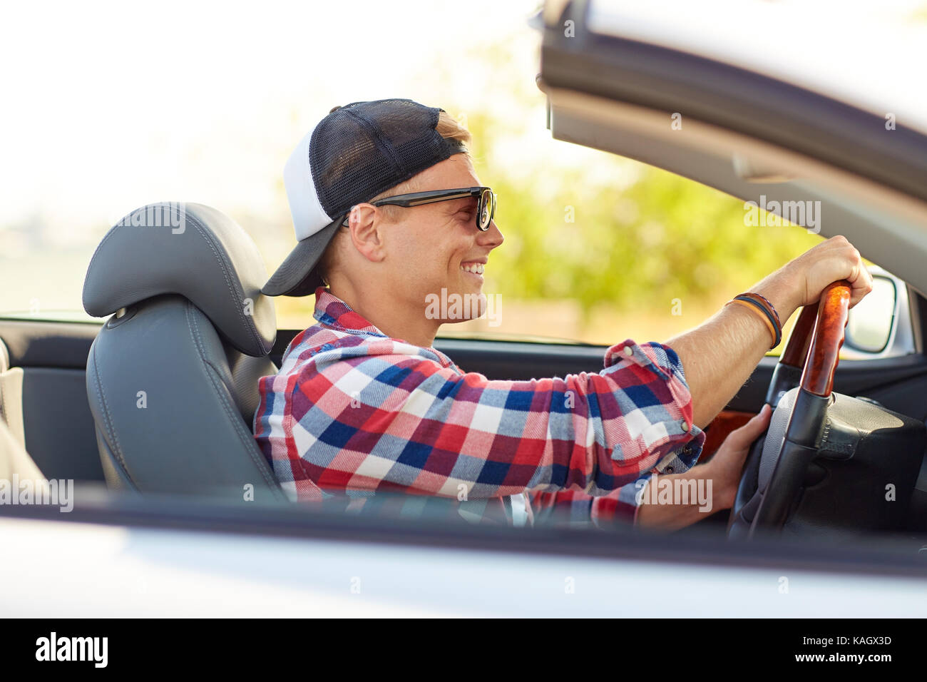 happy young man in shades driving convertible car Stock Photo - Alamy