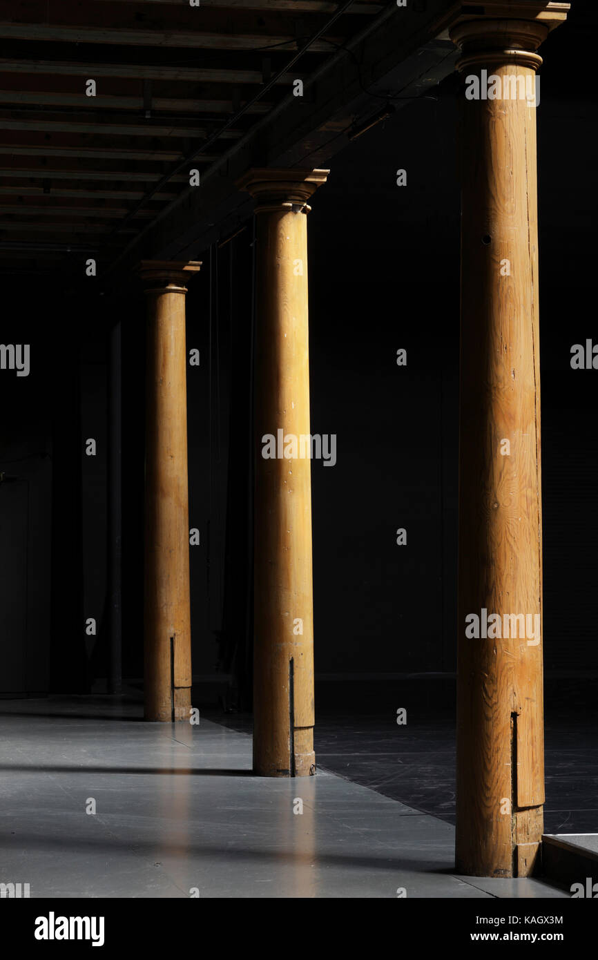 Light and shadow on neo-classical timber pillars at entrance to ...