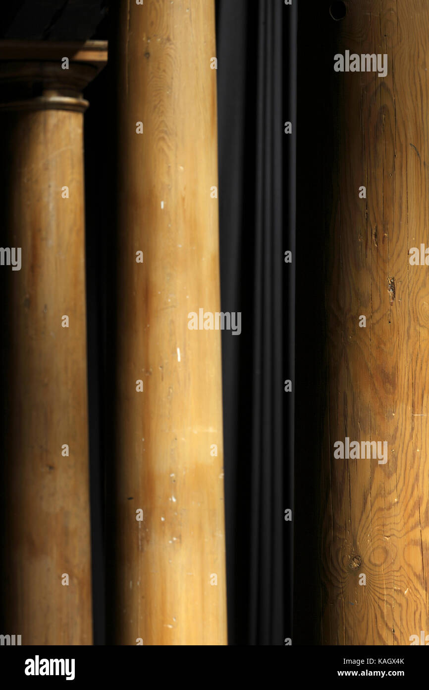 Light and shadow on neo-classical timber pillars at entrance to main ...