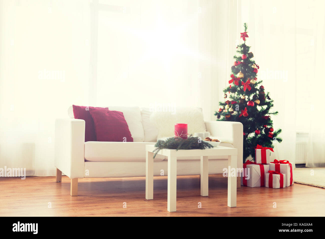 sofa, table and christmas tree with gifts at home Stock Photo - Alamy