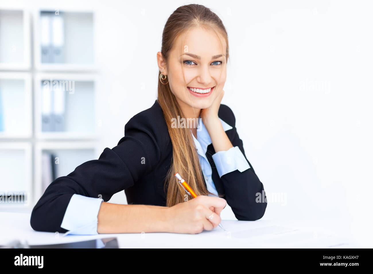 Portrait of a beautiful young business woman doing some paperwork in ...