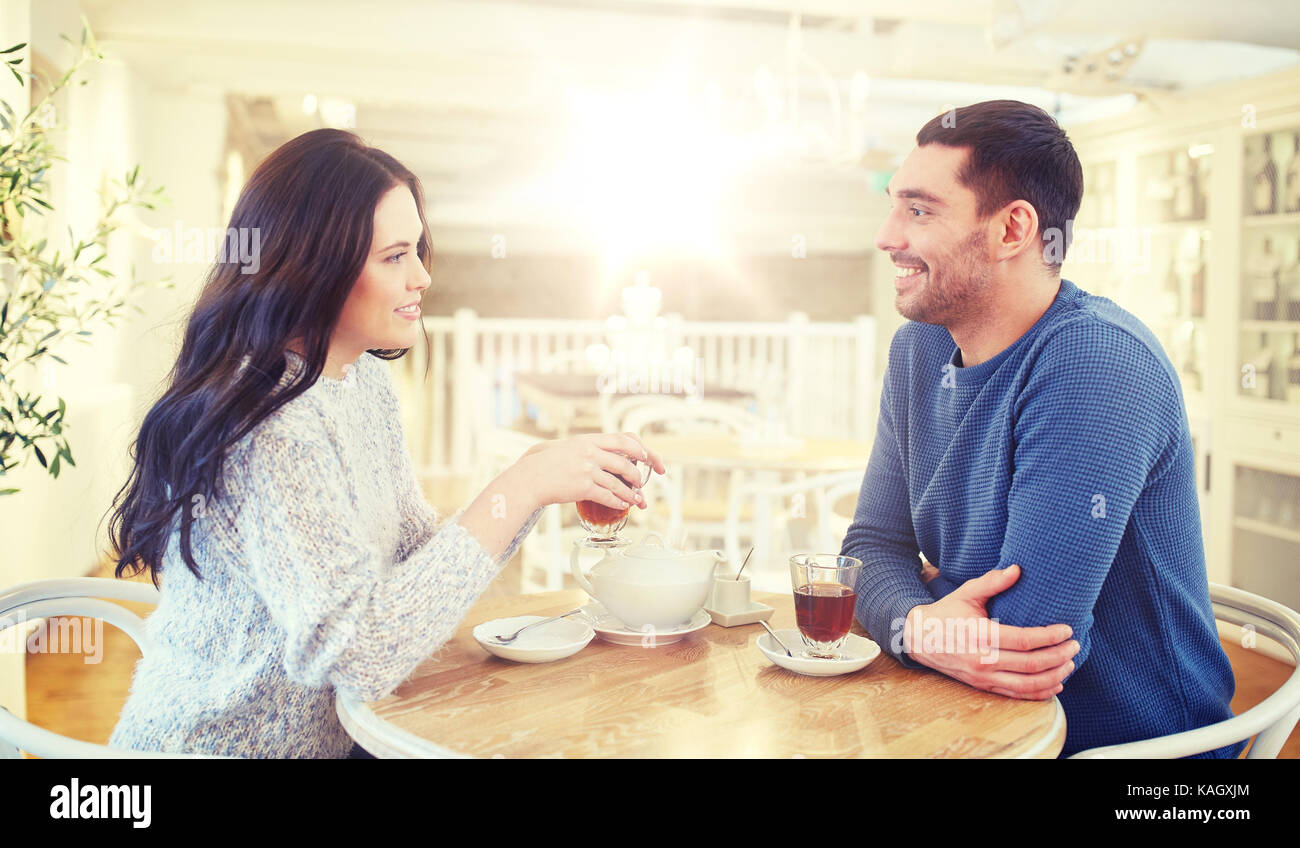 happy couple drinking tea at cafe Stock Photo - Alamy