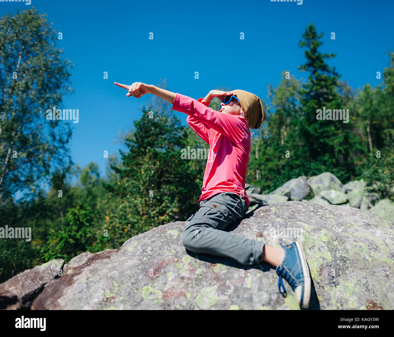 Сute little girl pointing direction hand up in mountain. Childhood ...