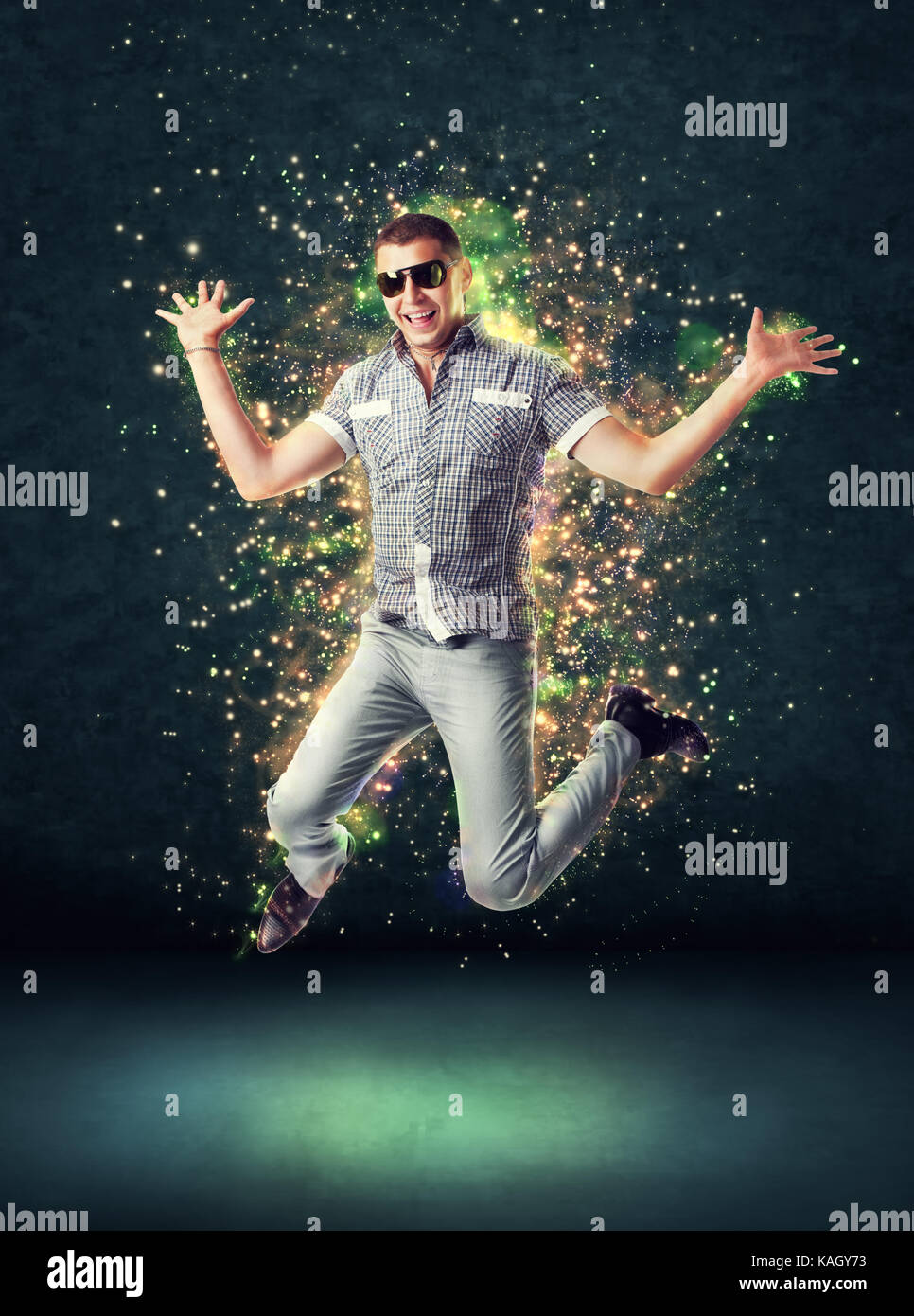 Jumping smiling young man on glowing abstract background Stock Photo ...