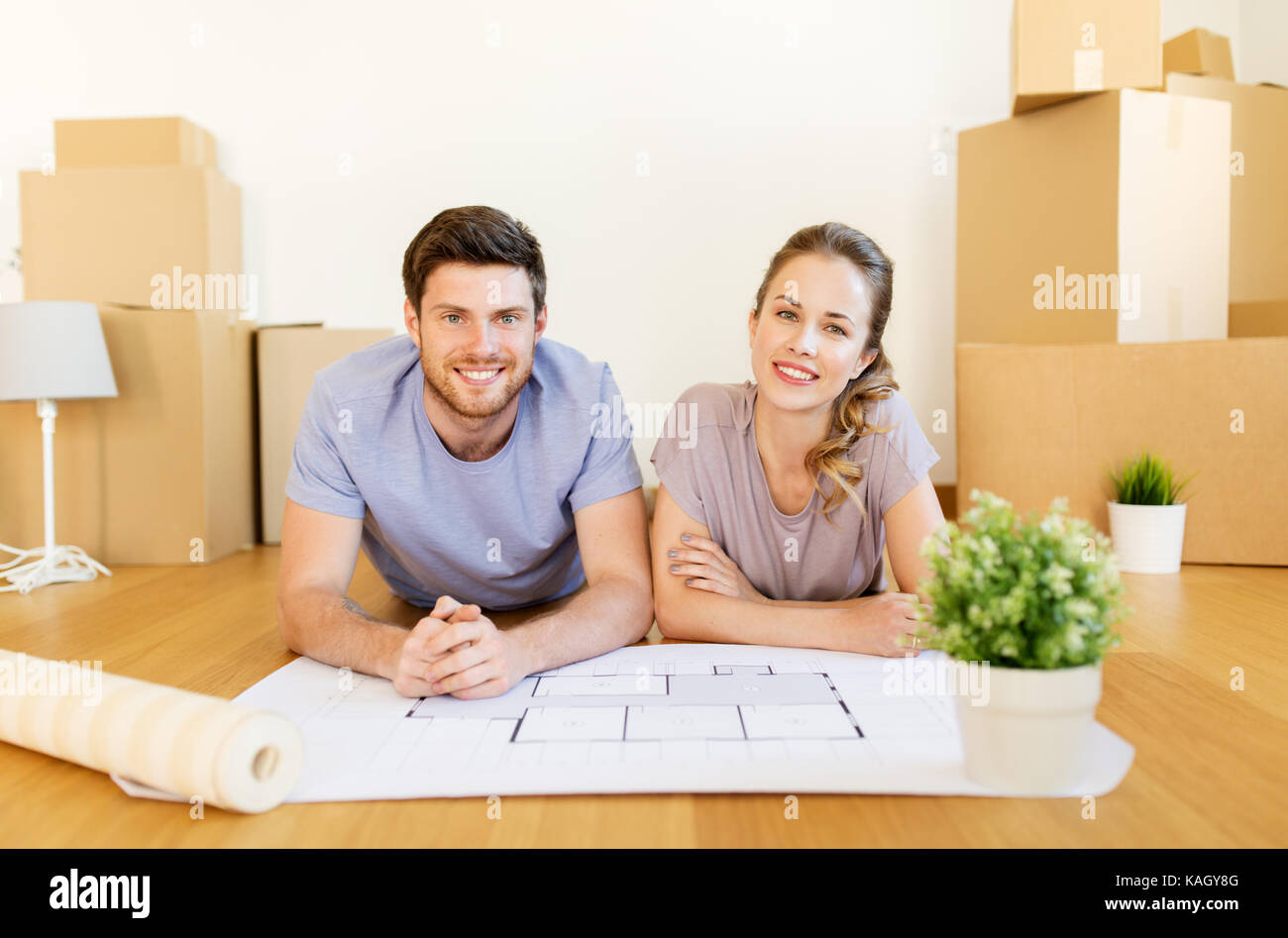 couple with boxes and blueprint moving to new home Stock Photo - Alamy