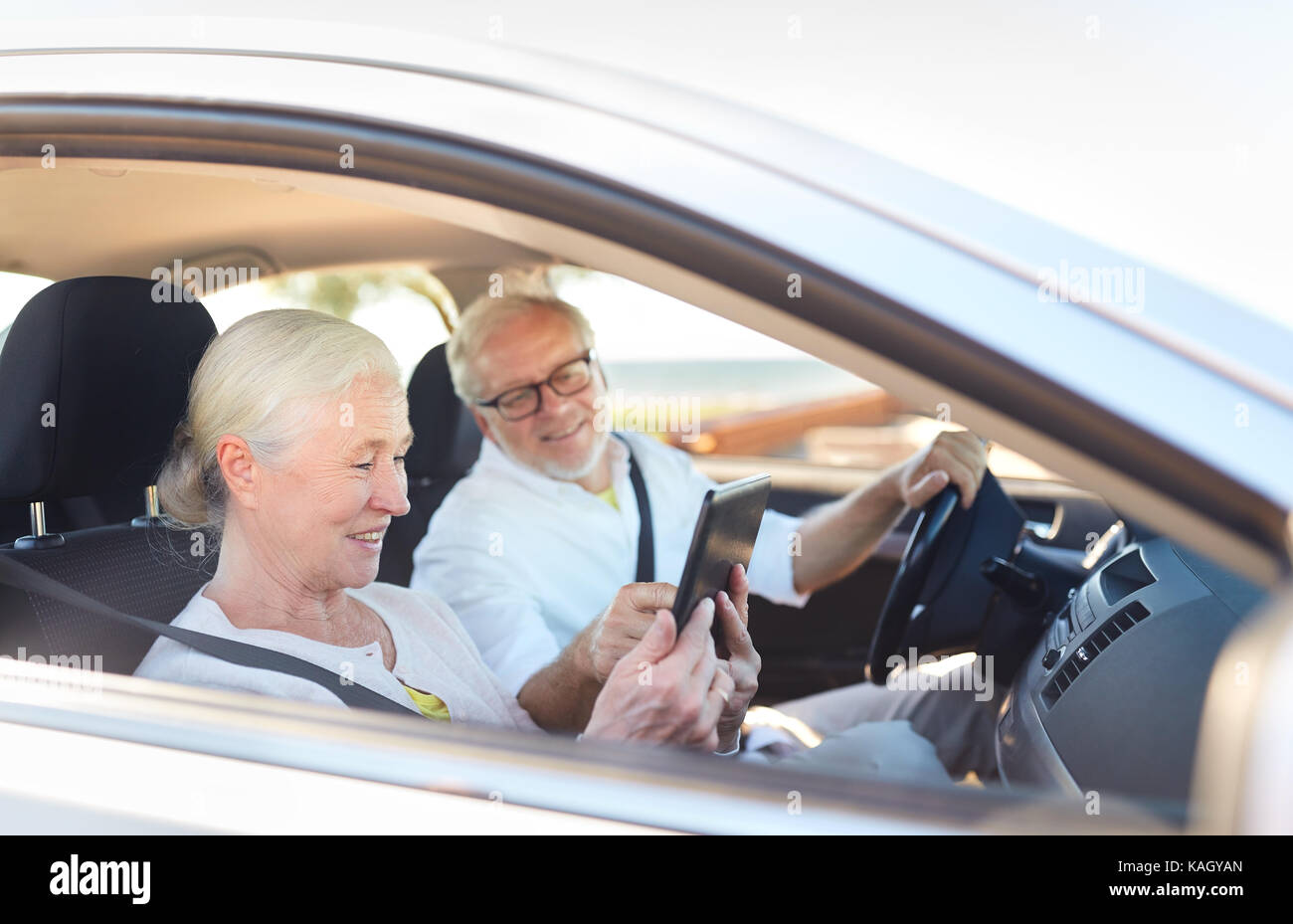 happy senior couple with tablet pc driving in car Stock Photo - Alamy