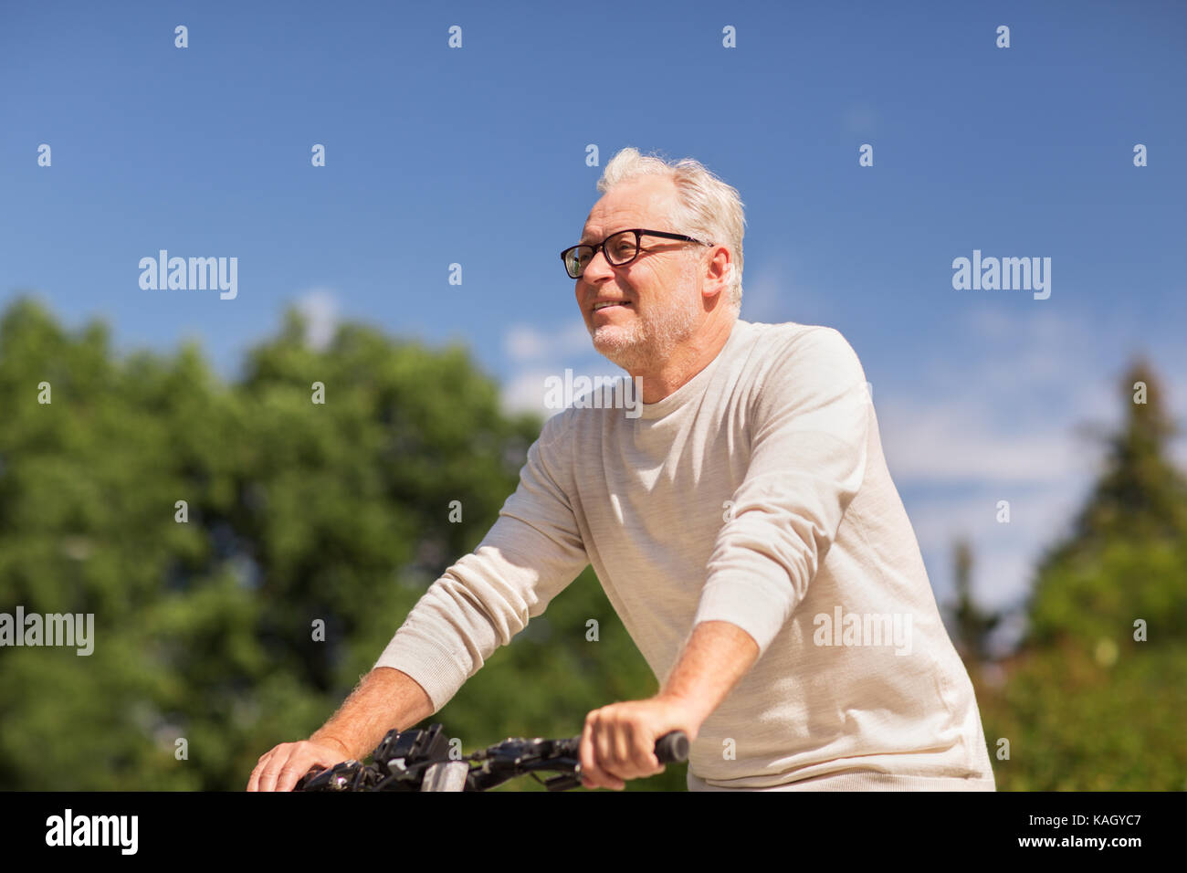 Old man riding bicycle hi-res stock photography and images - Alamy
