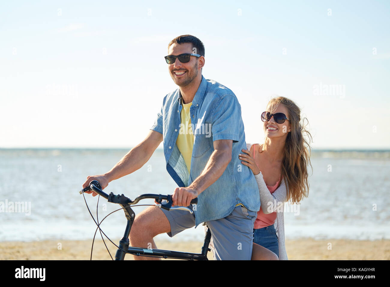 Woman riding bike on beach hi-res stock photography and images - Alamy