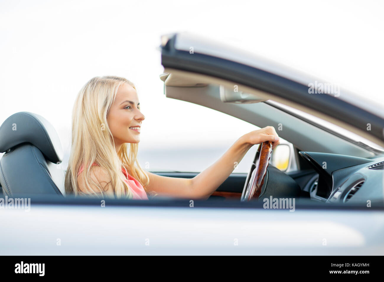 happy young woman driving convertible car Stock Photo - Alamy