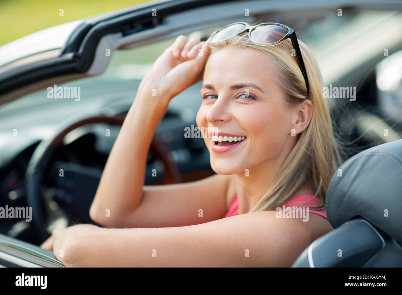 happy young woman in convertible car Stock Photo - Alamy