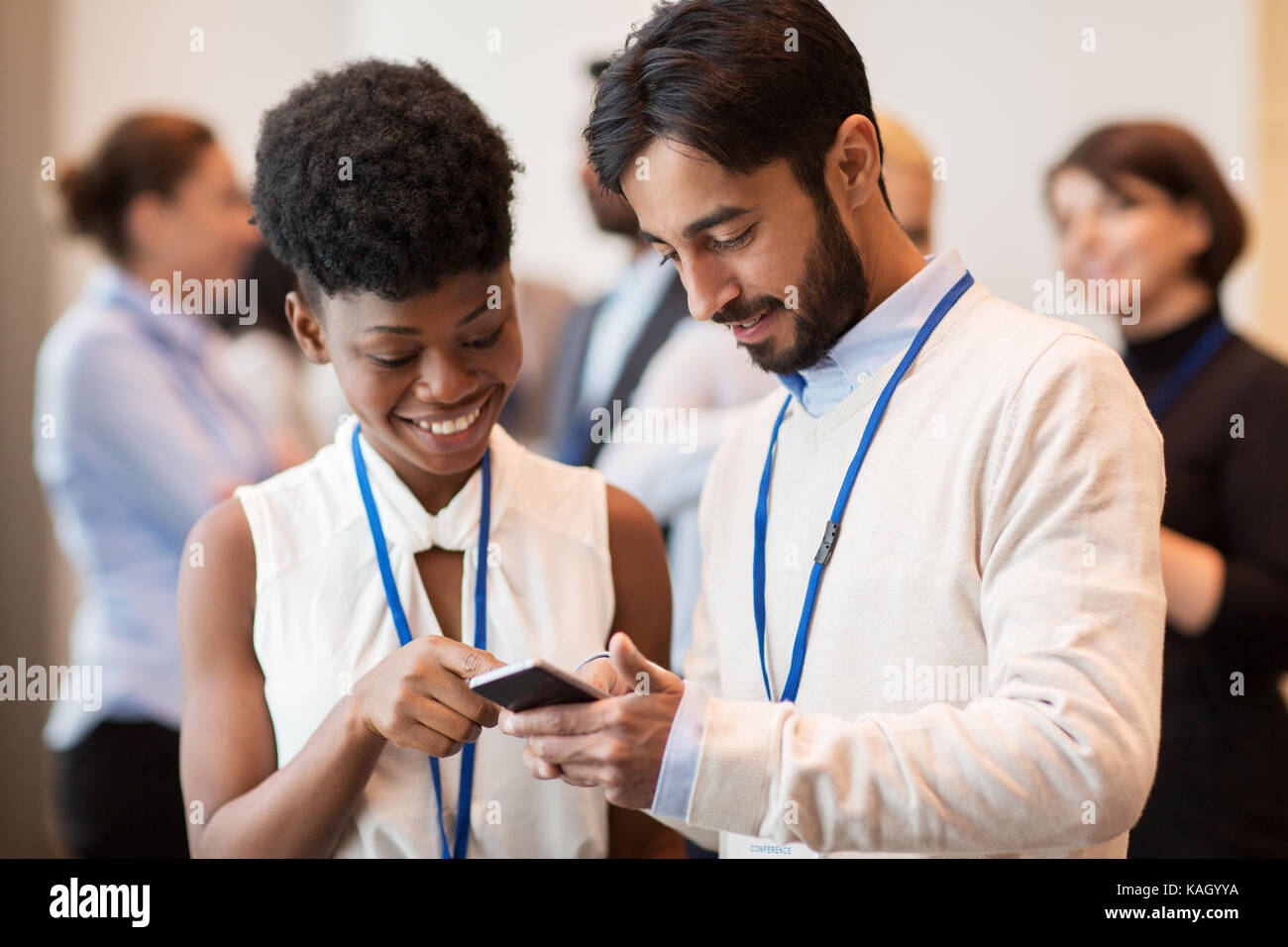 couple with smartphone at business conference Stock Photo - Alamy