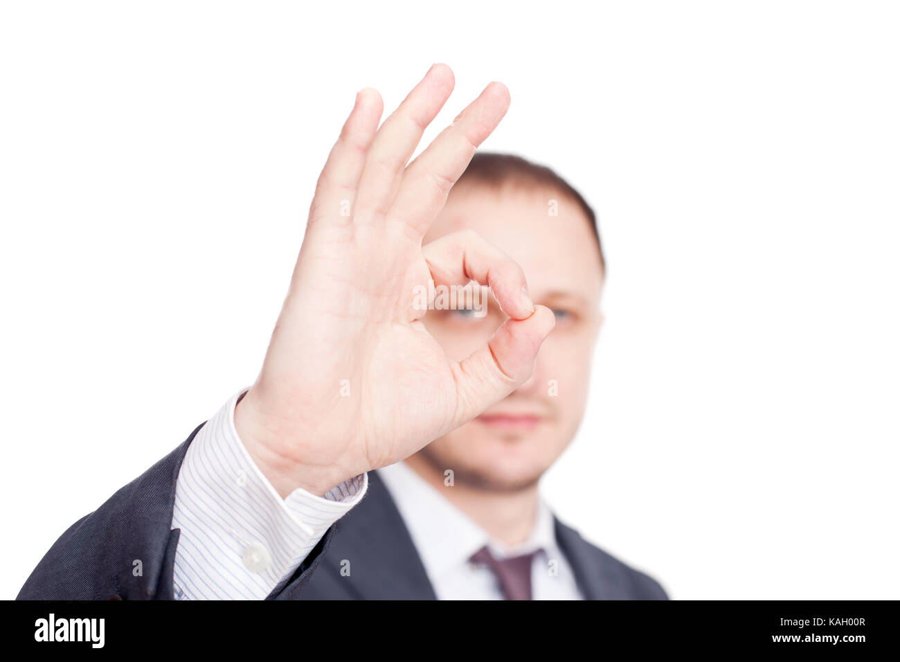 Young businessman showing symbol OK isolated on white background Stock ...