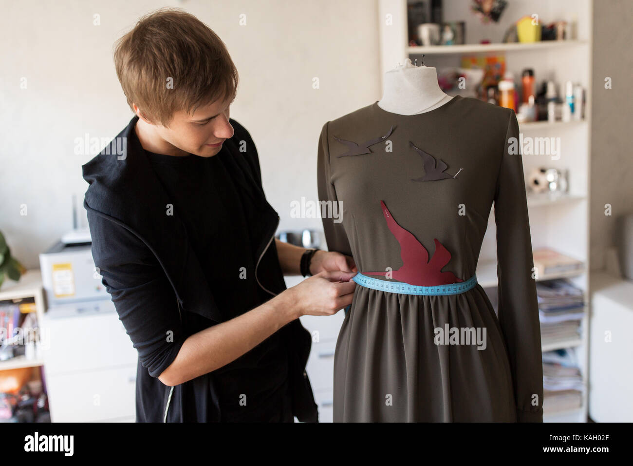 fashion designer with dummy making dress at studio Stock Photo - Alamy