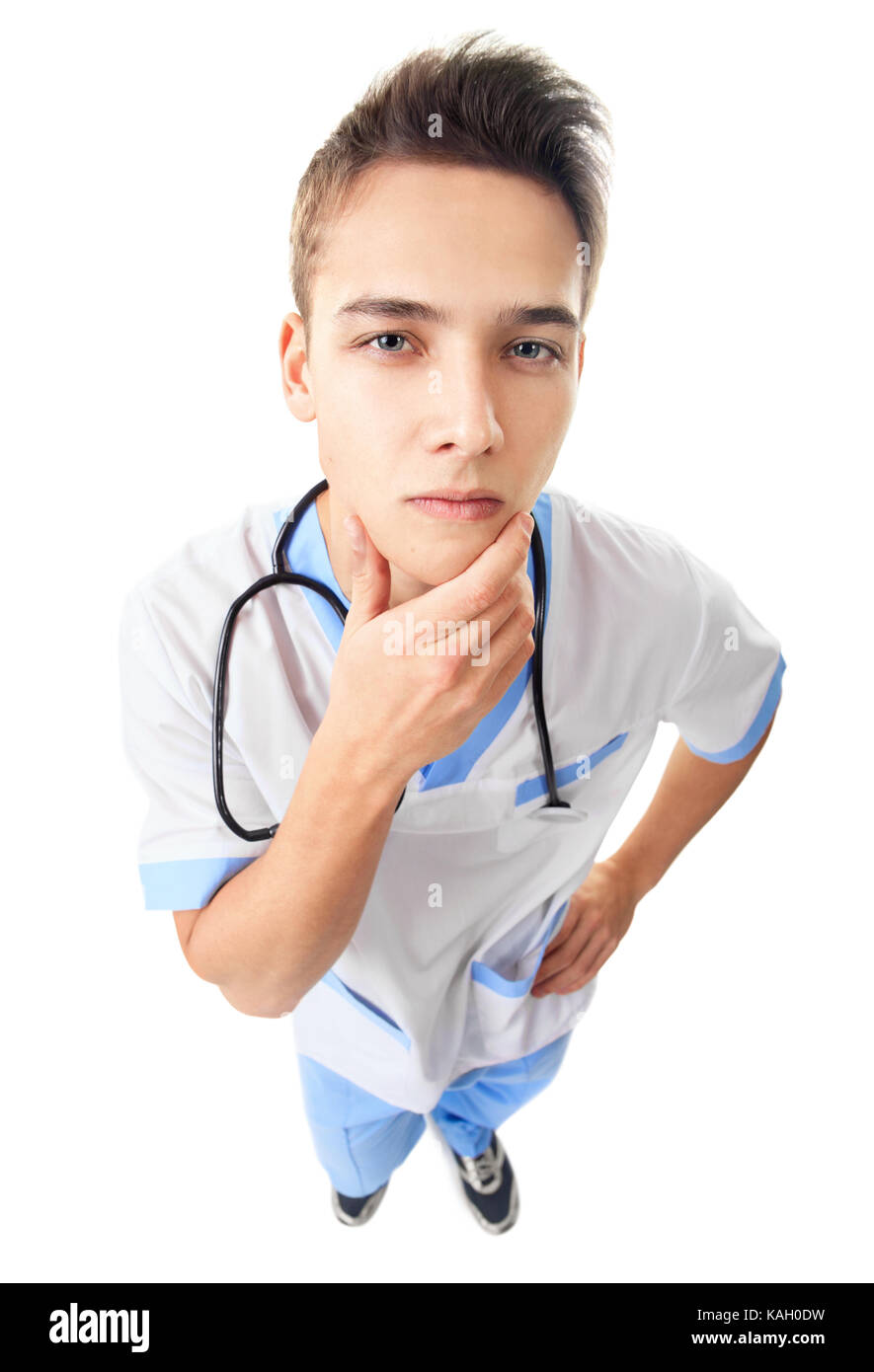 Wide angle top view of thinking young doctor looking up contemplative ...