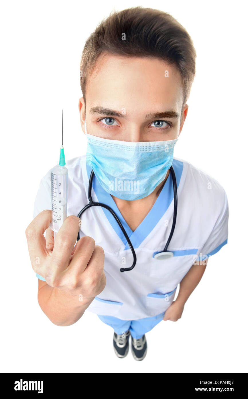 Wide angle top view of young doctor wearing mask holding syringe for ...