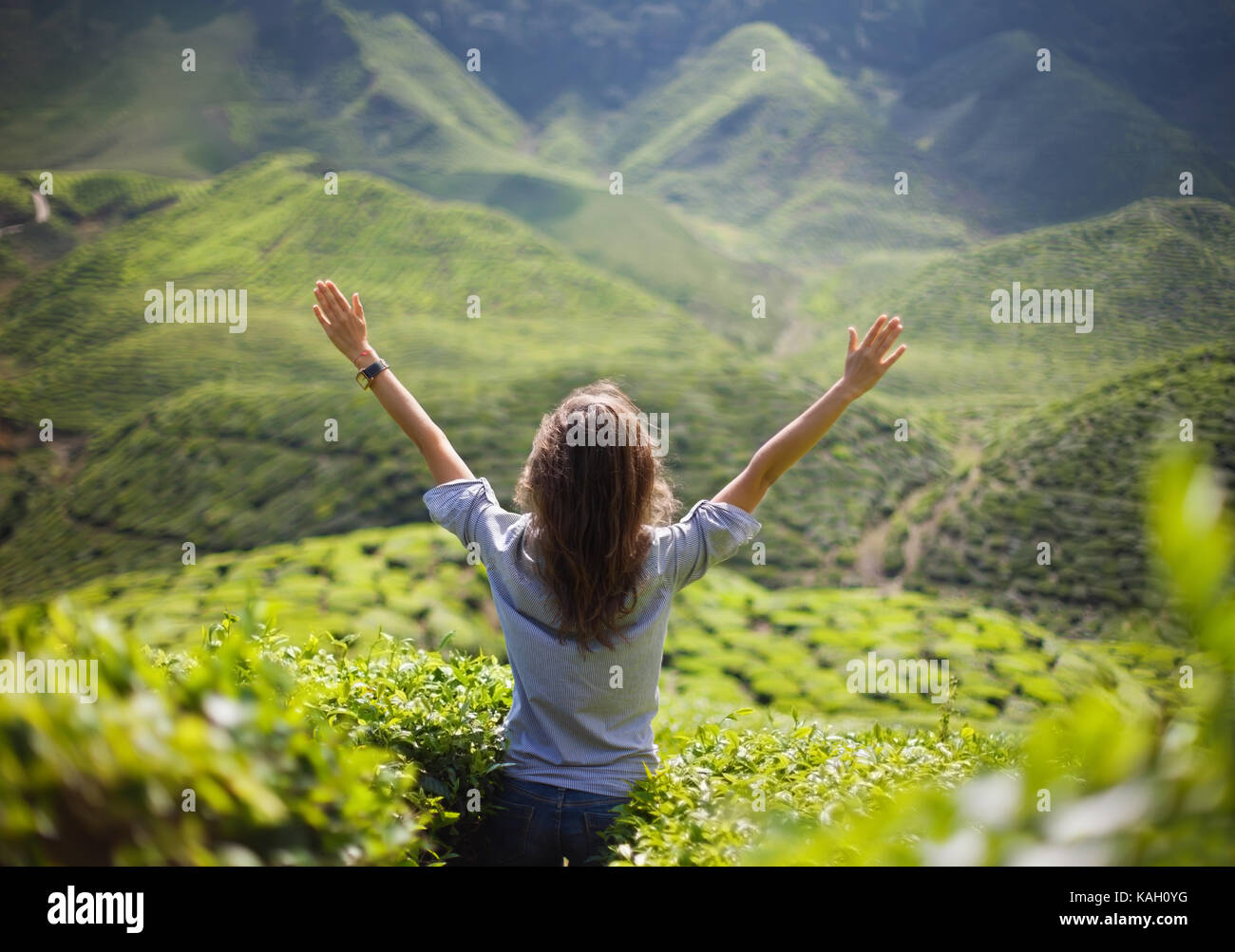 freedom girl with hands up in mountains Stock Photo - Alamy