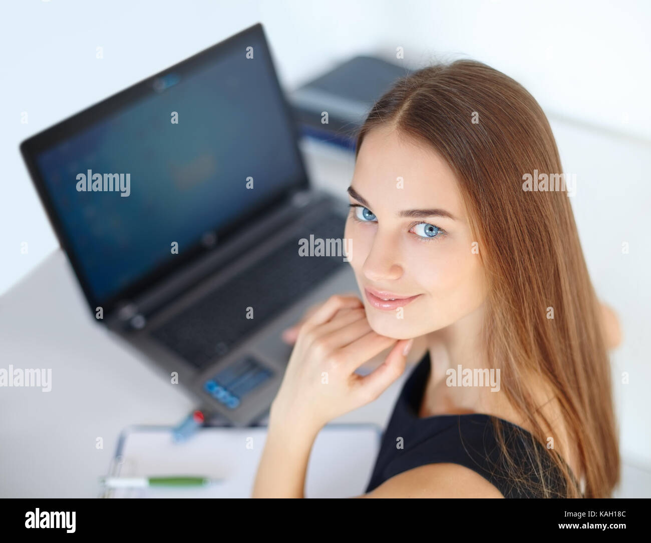 Top view portrait of beautiful young business woman working on a laptop ...