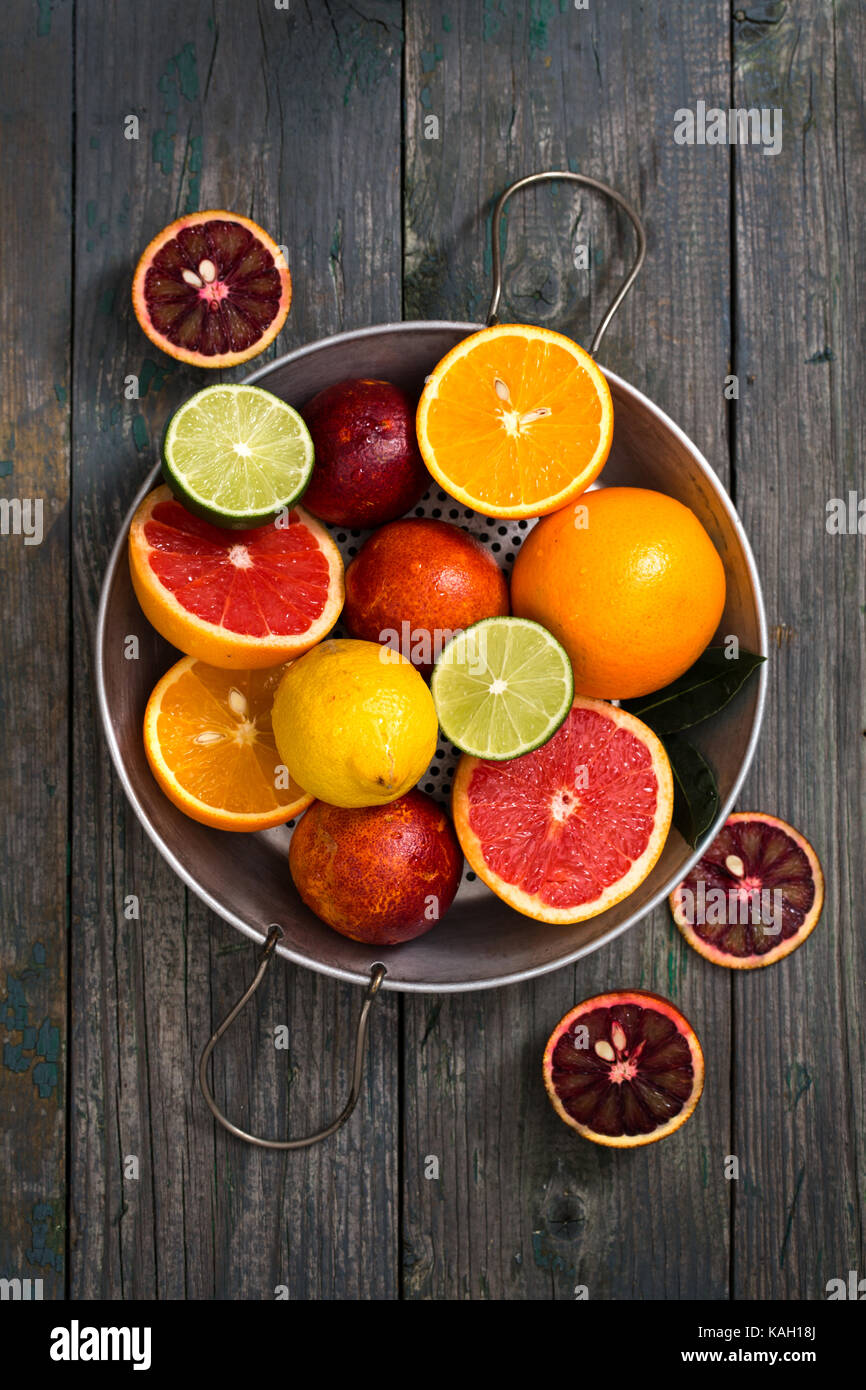 Citrus fruits in a metal colander Stock Photo - Alamy