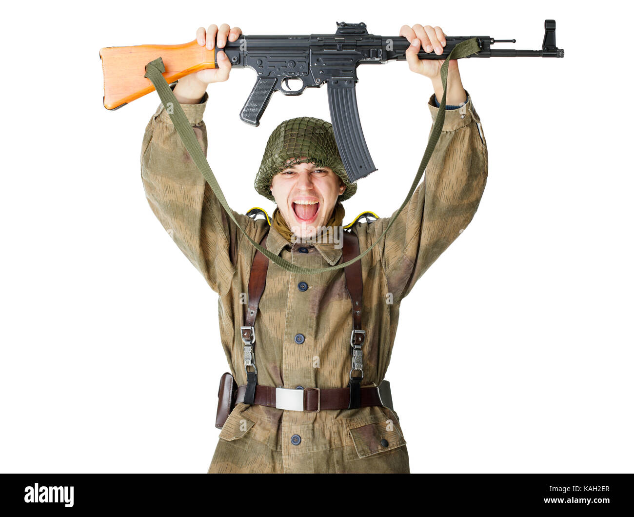 Soldier holding machine gun over head isolated on white background ...