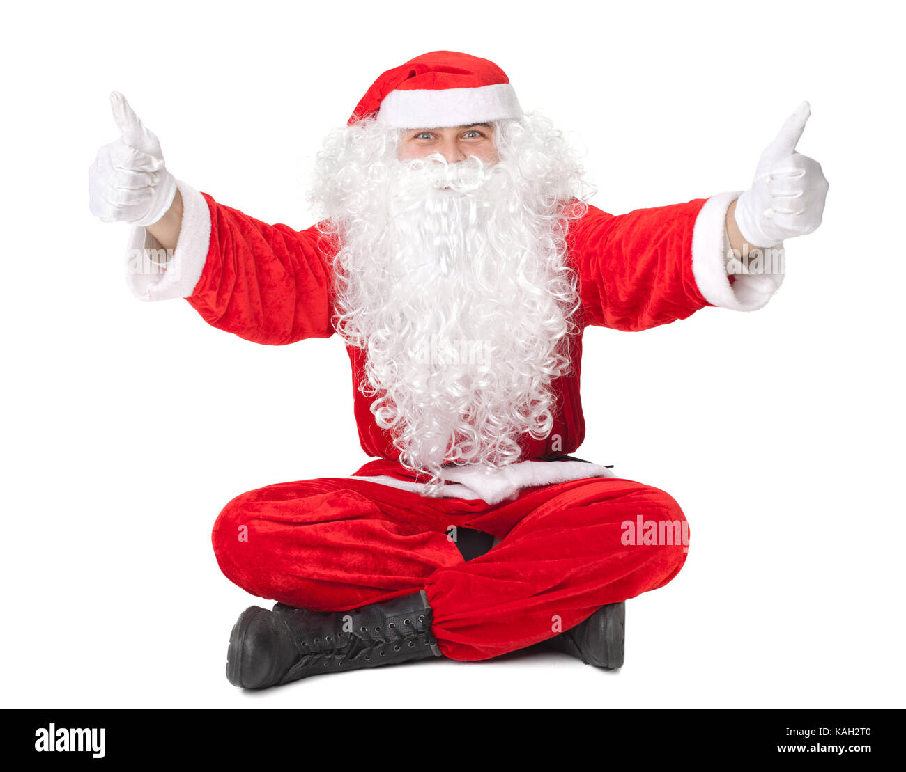 Santa Claus sitting on floor with thumb up sign isolated on white ...