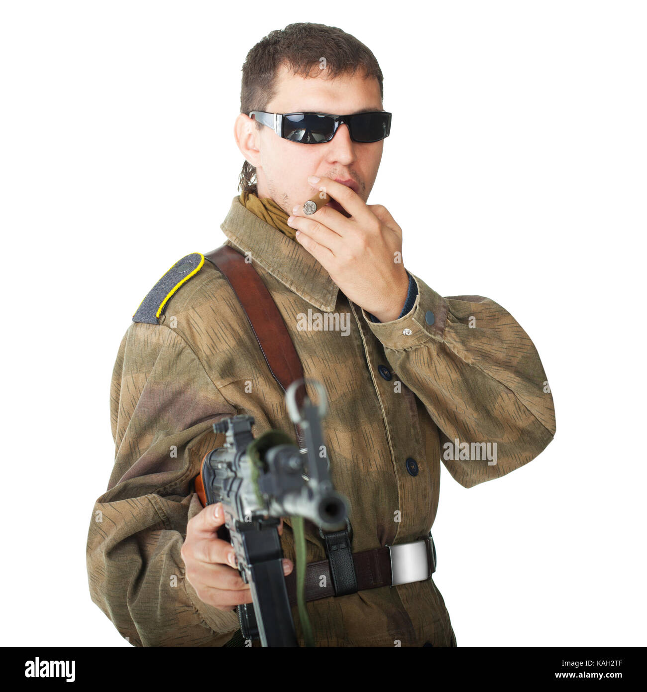 Soldier wearing sunglasses with machine gun smoking a cigar isolated on ...