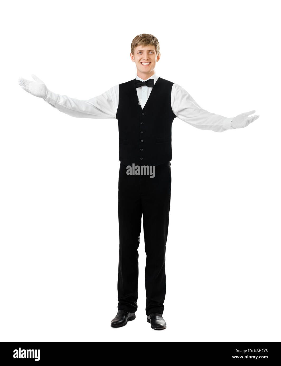 Full length portrait of young handsome waiter gesturing welcome ...