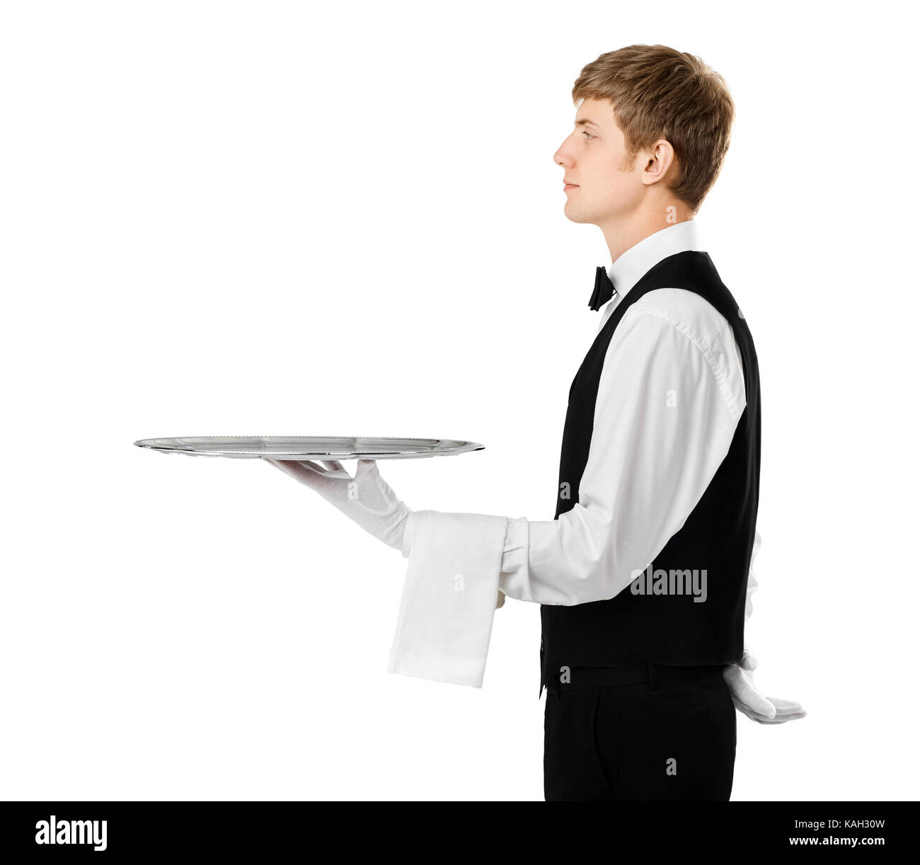 Profile portrait of young handsome waiter holding empty tray with copy ...