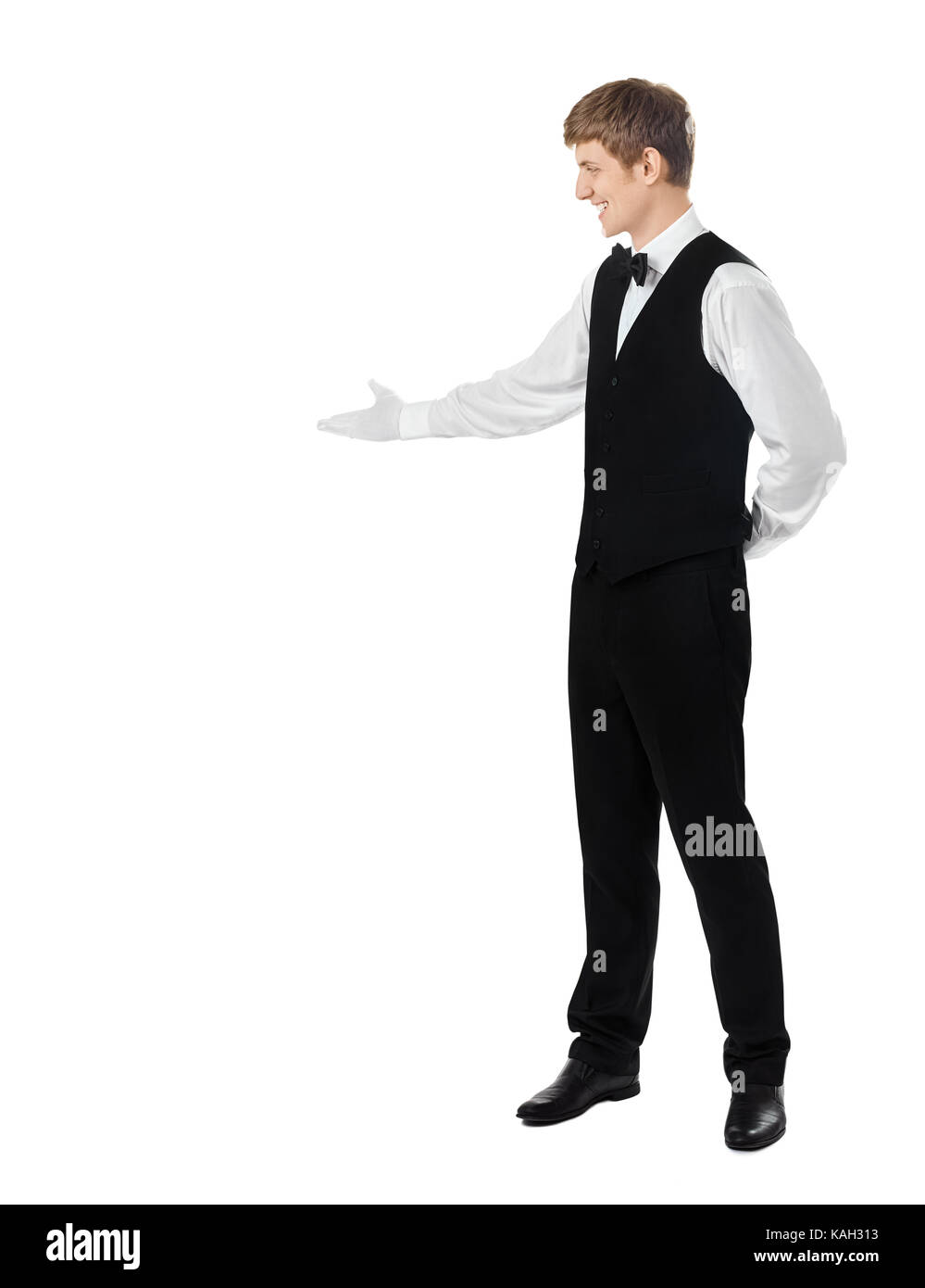 Young handsome waiter doing a welcome gesture isolated on white ...