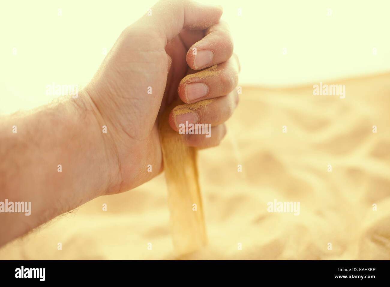 Sand strewing from hand at beach background Stock Photo - Alamy