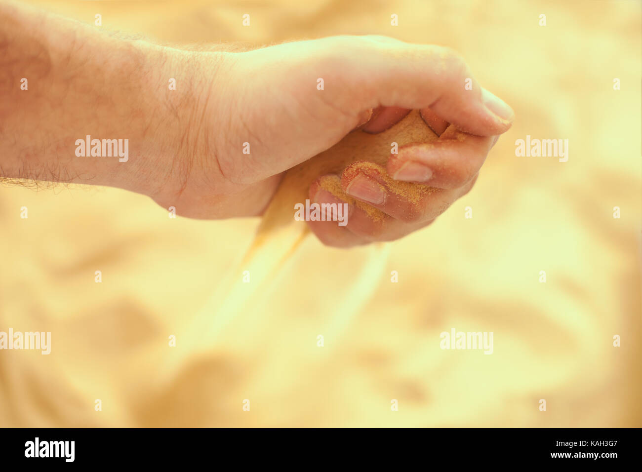 Sand strewing from hand at beach background Stock Photo - Alamy