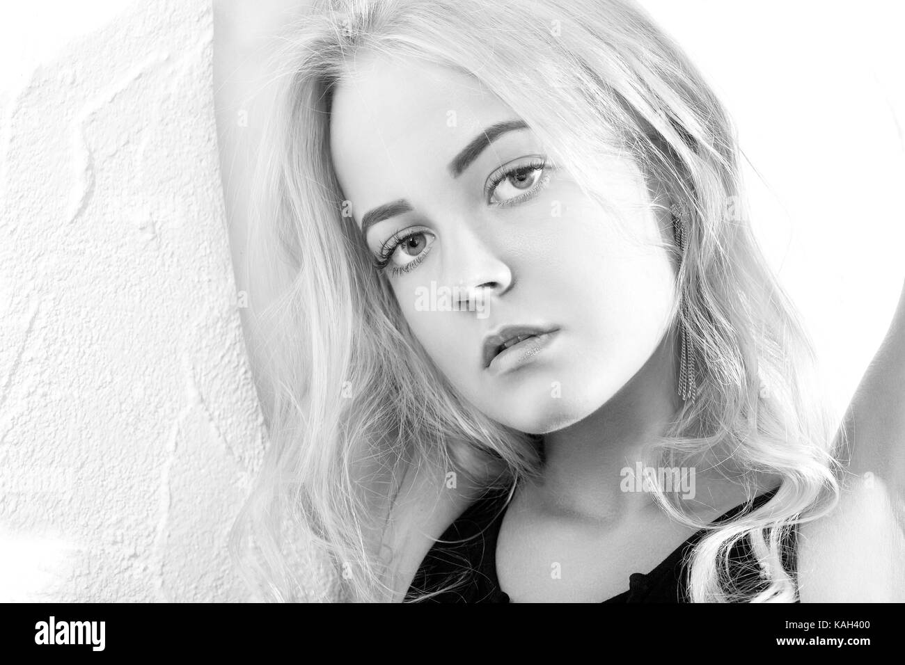 Sensual Young Woman Near White Wall Looking At Camera Monochrome Stock 5469