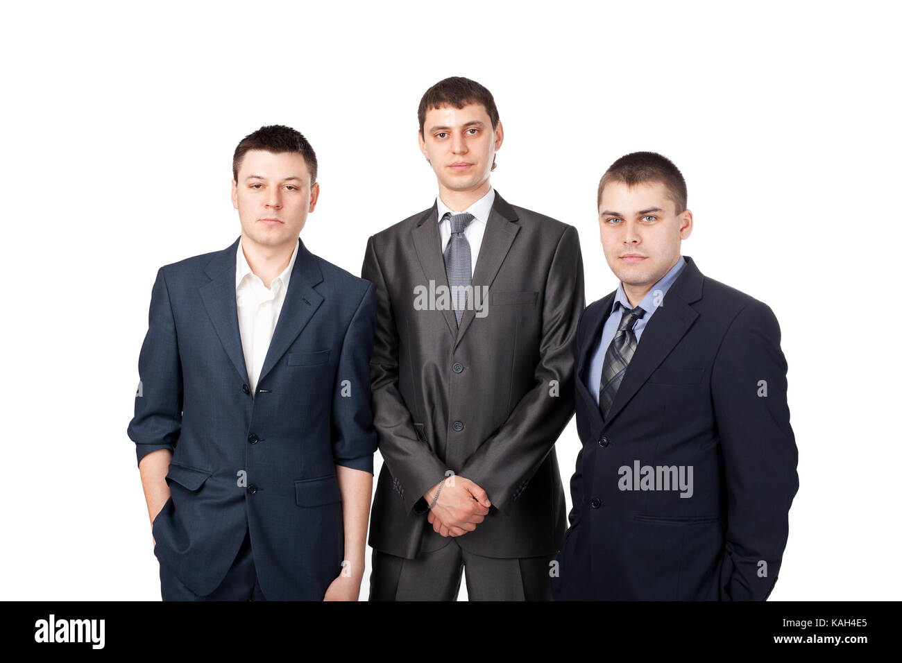 Three young business men standing isolated on white background Stock ...