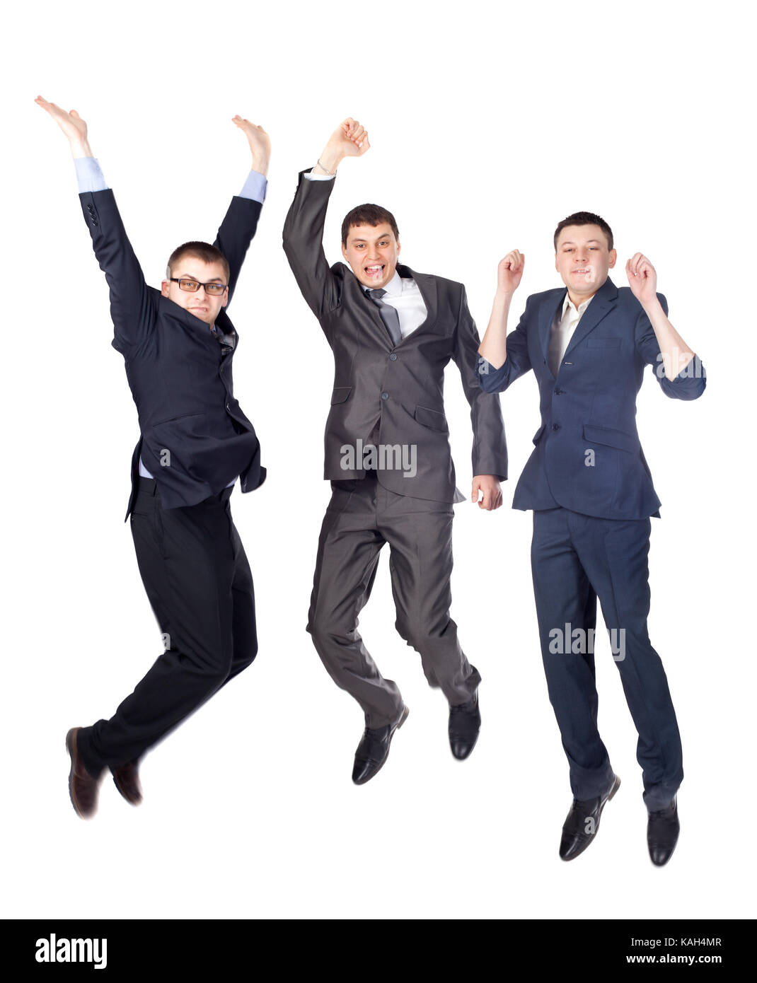 Three young business men jumping isolated on white background Stock ...