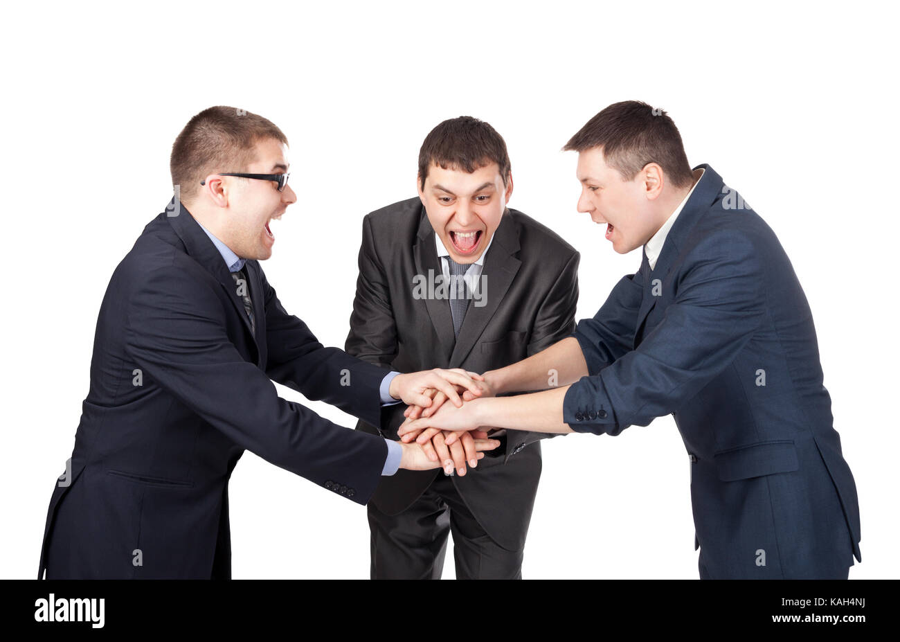 Three laughing partners putting their hands on the top isolated on ...