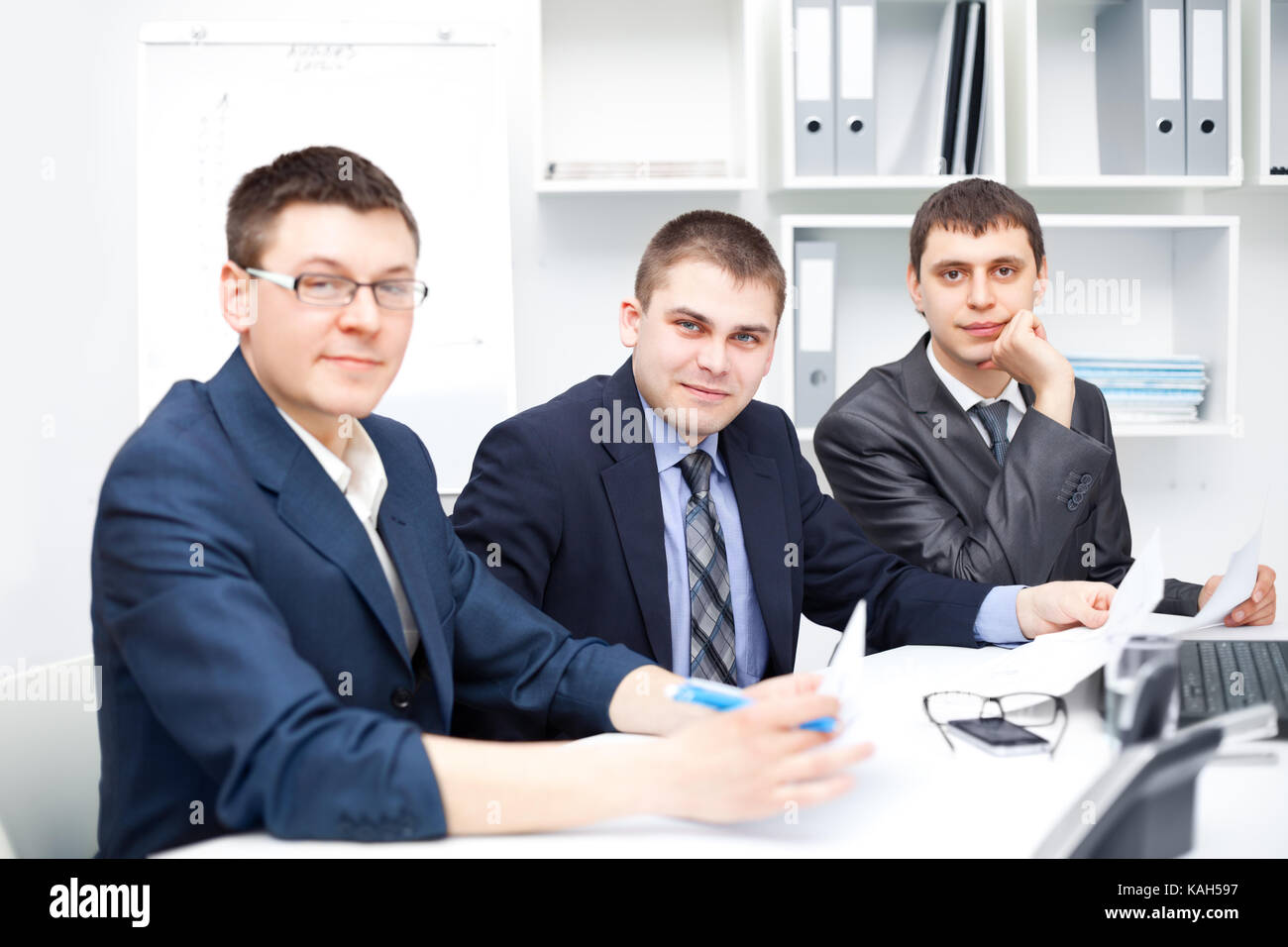 Team of young business men working together at office Stock Photo - Alamy