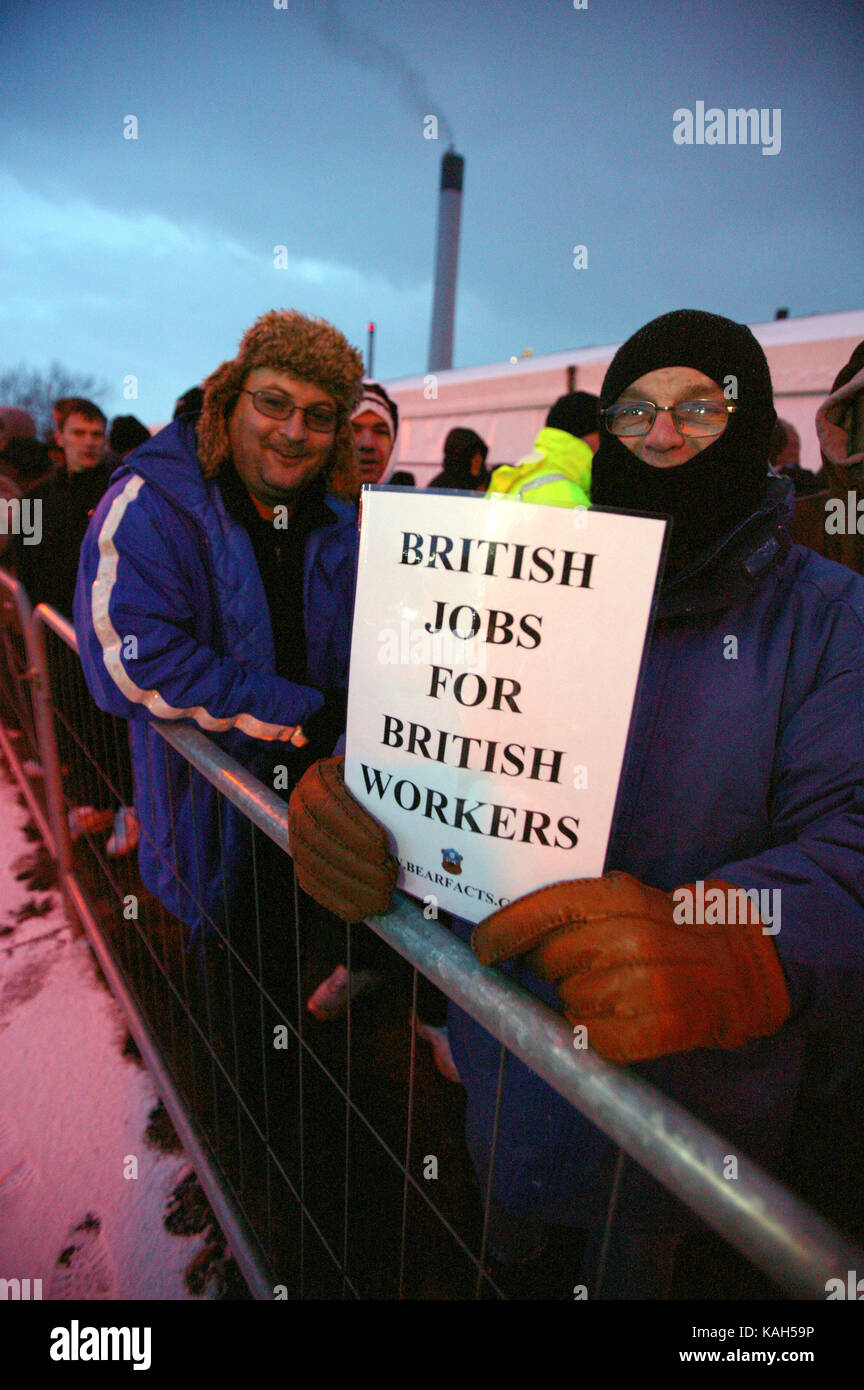 A man holds a "British jobs for British workers" sign during wildcat ...
