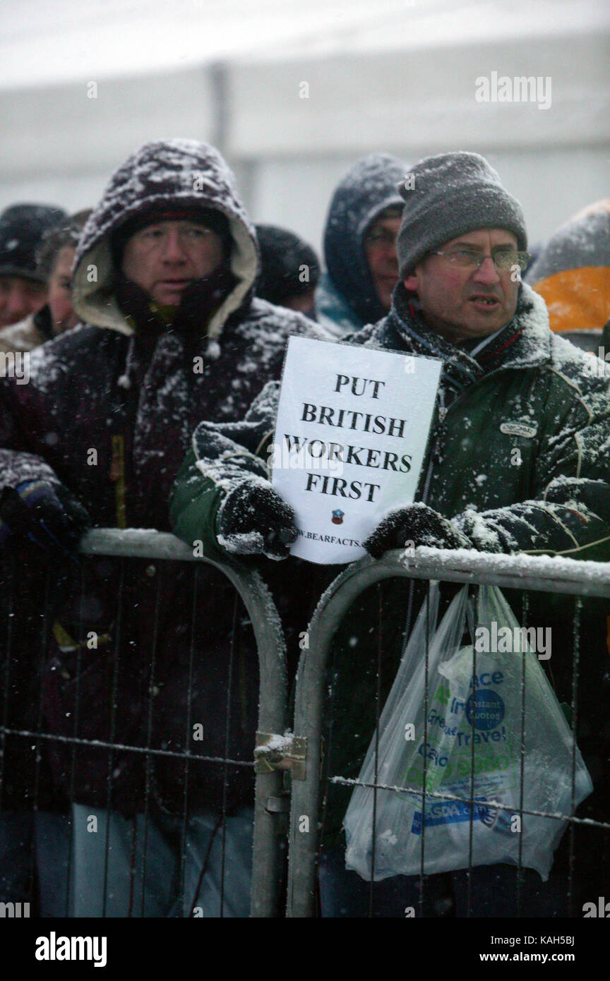 A man holds a "Put British Workers First" sign during wildcat strikes ...