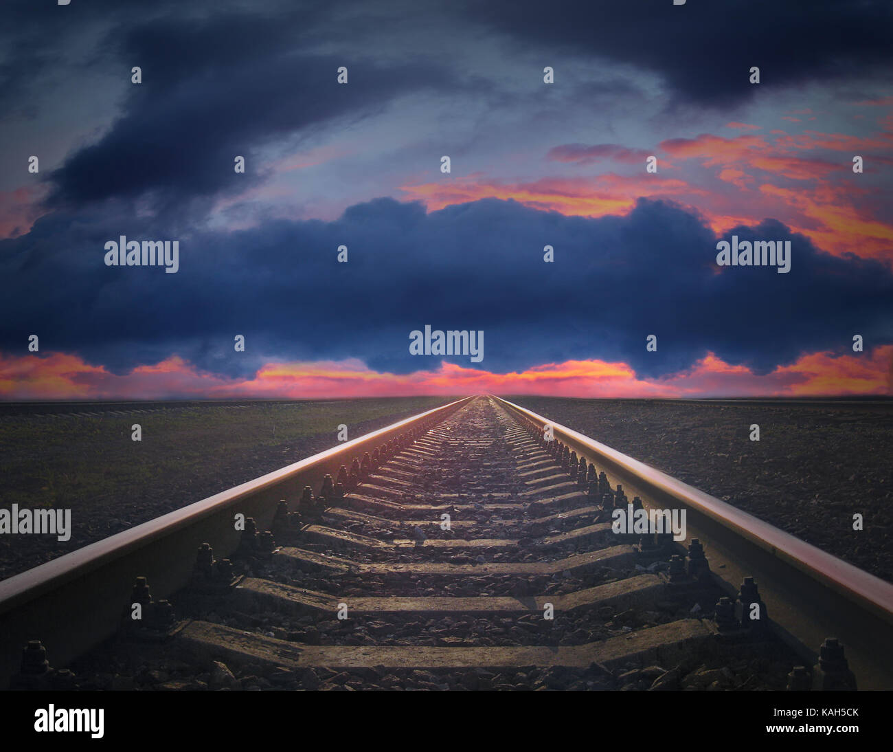 rails going away into the gloomy landscape. Black and white image with ...