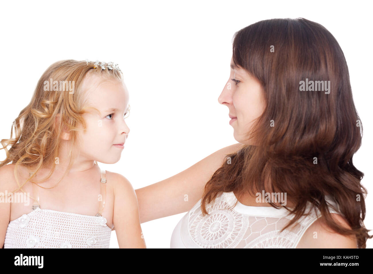 mother and daughter looking each other in eyes isolated on white ...