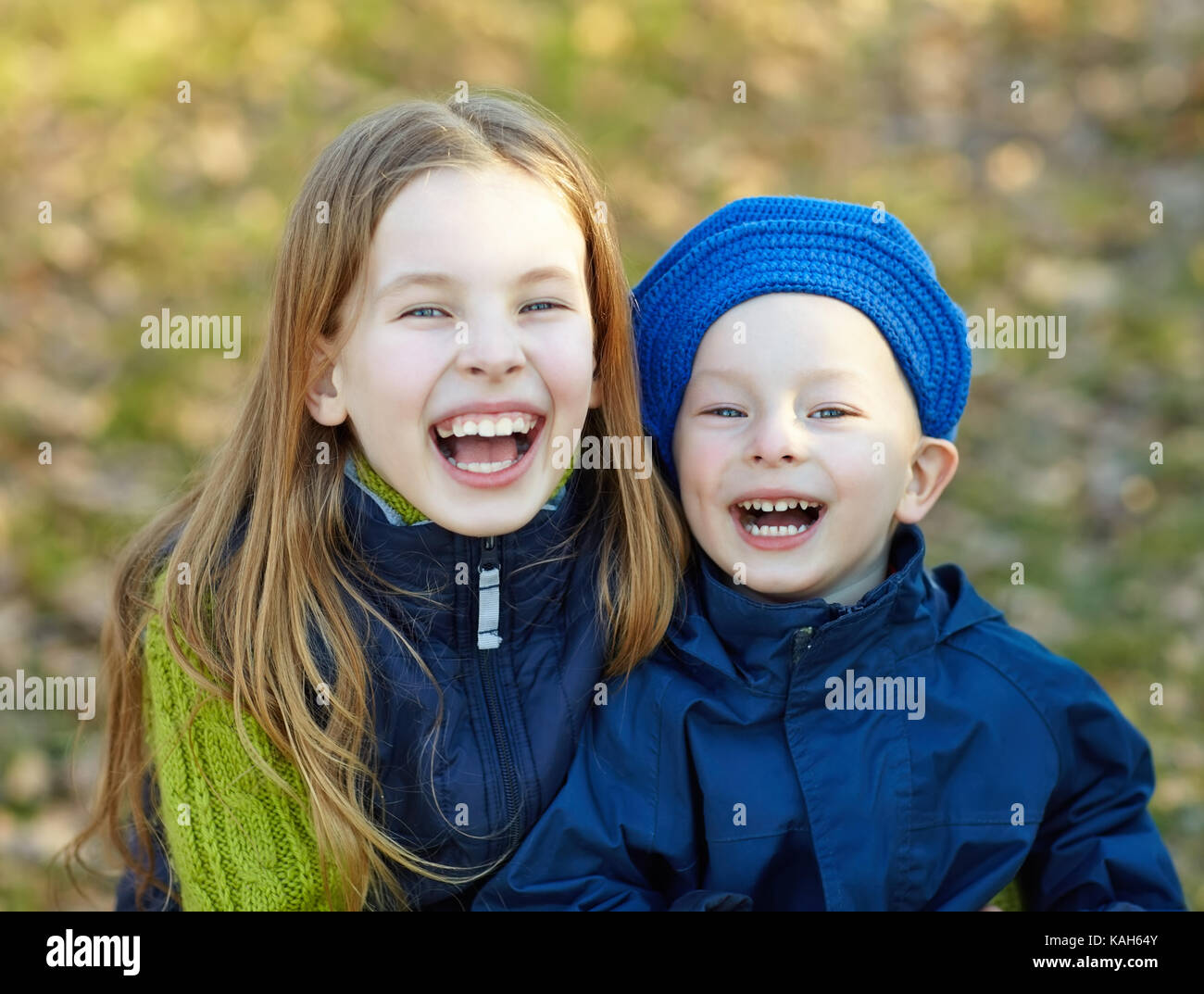 Happy sister and brother having fun in autumn park. Happy lifestyle kids Stock Photo - Alamy