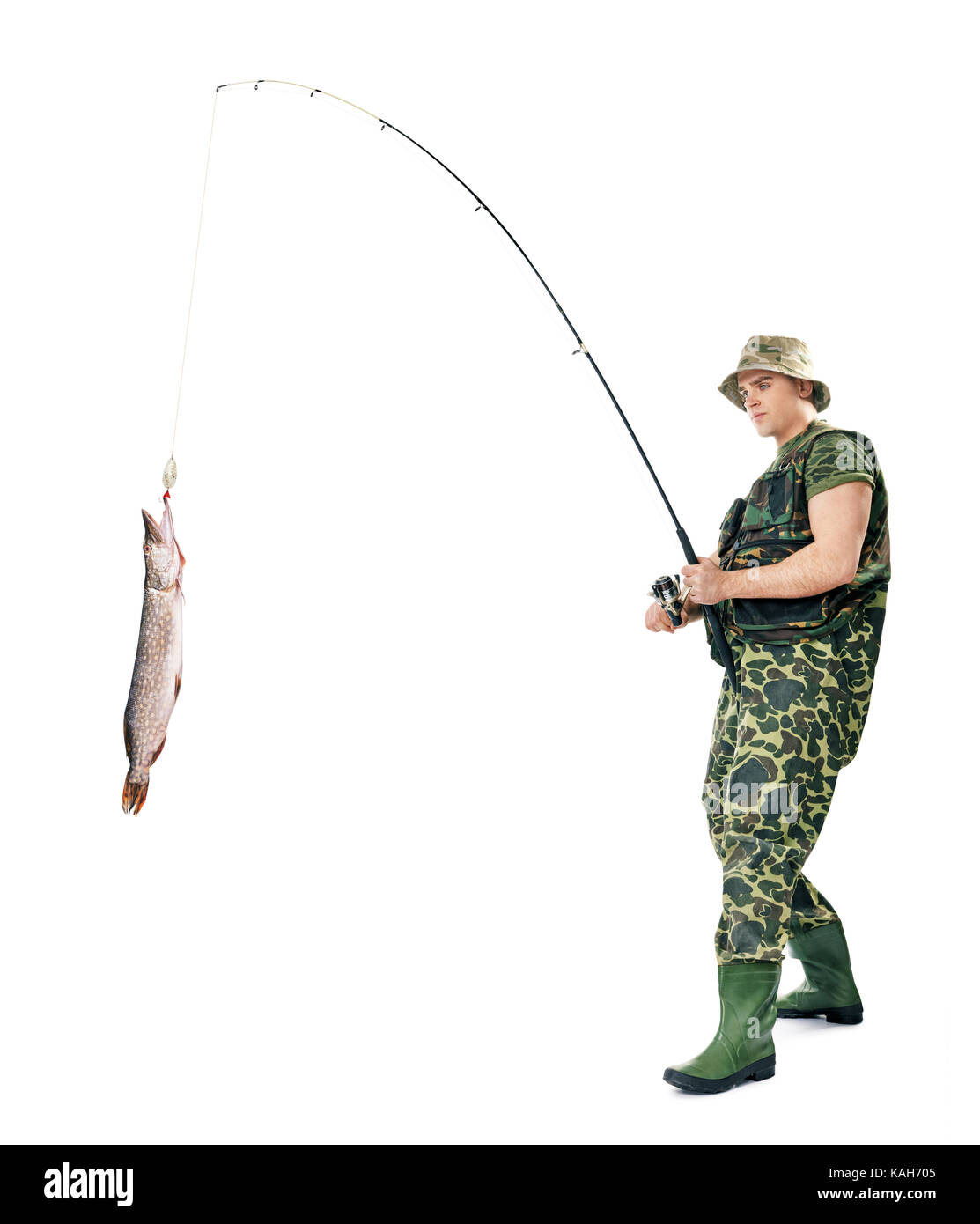 Full length portrait of a young fisherman catching a fish isolated on ...
