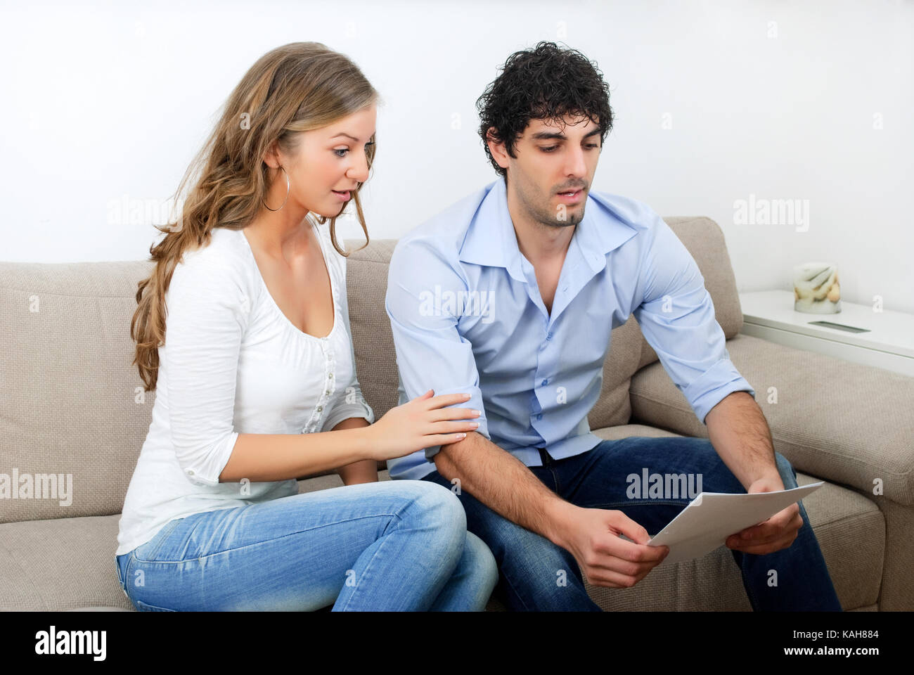 Man and woman settle apartment bills Stock Photo - Alamy