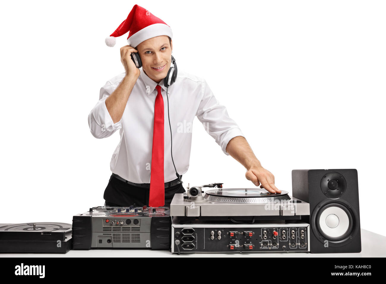 Elegant man with a santa hat playing music on a turntable and looking ...