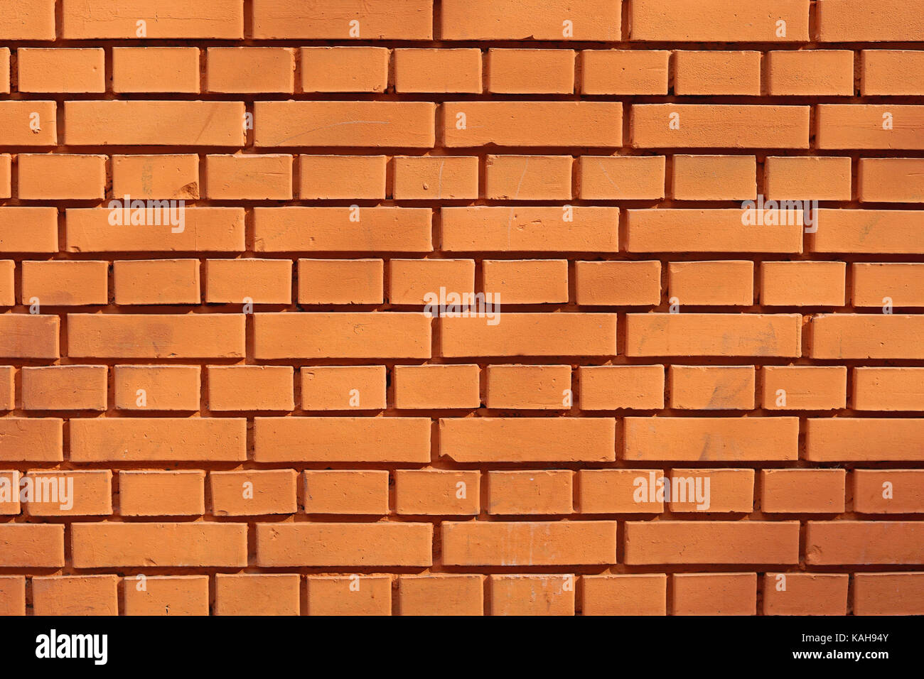 New orange brick wall background Stock Photo - Alamy