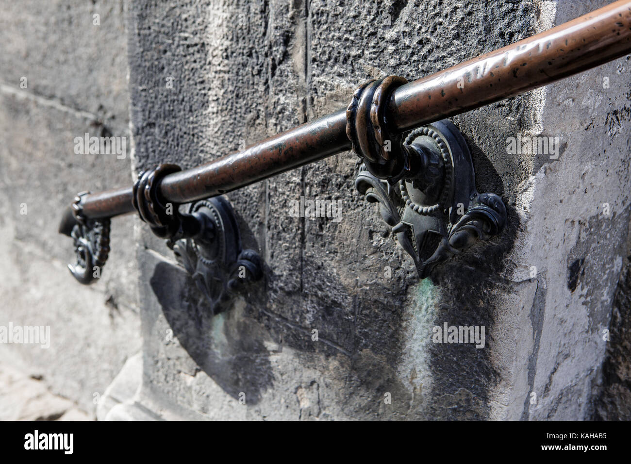 old metal forged handrails on a stone wall Stock Photo - Alamy