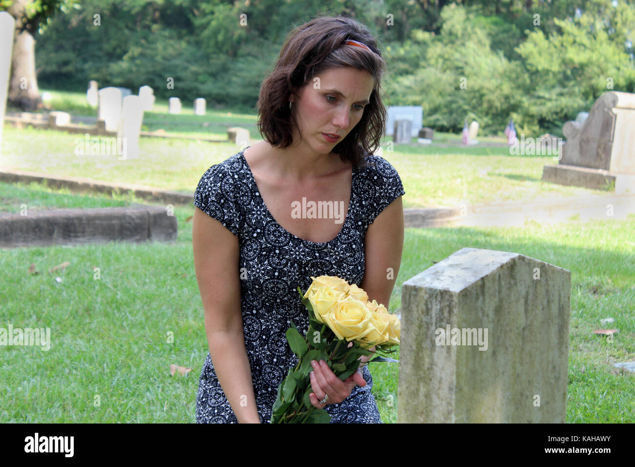 woman with flowers in cemetery Stock Photo - Alamy