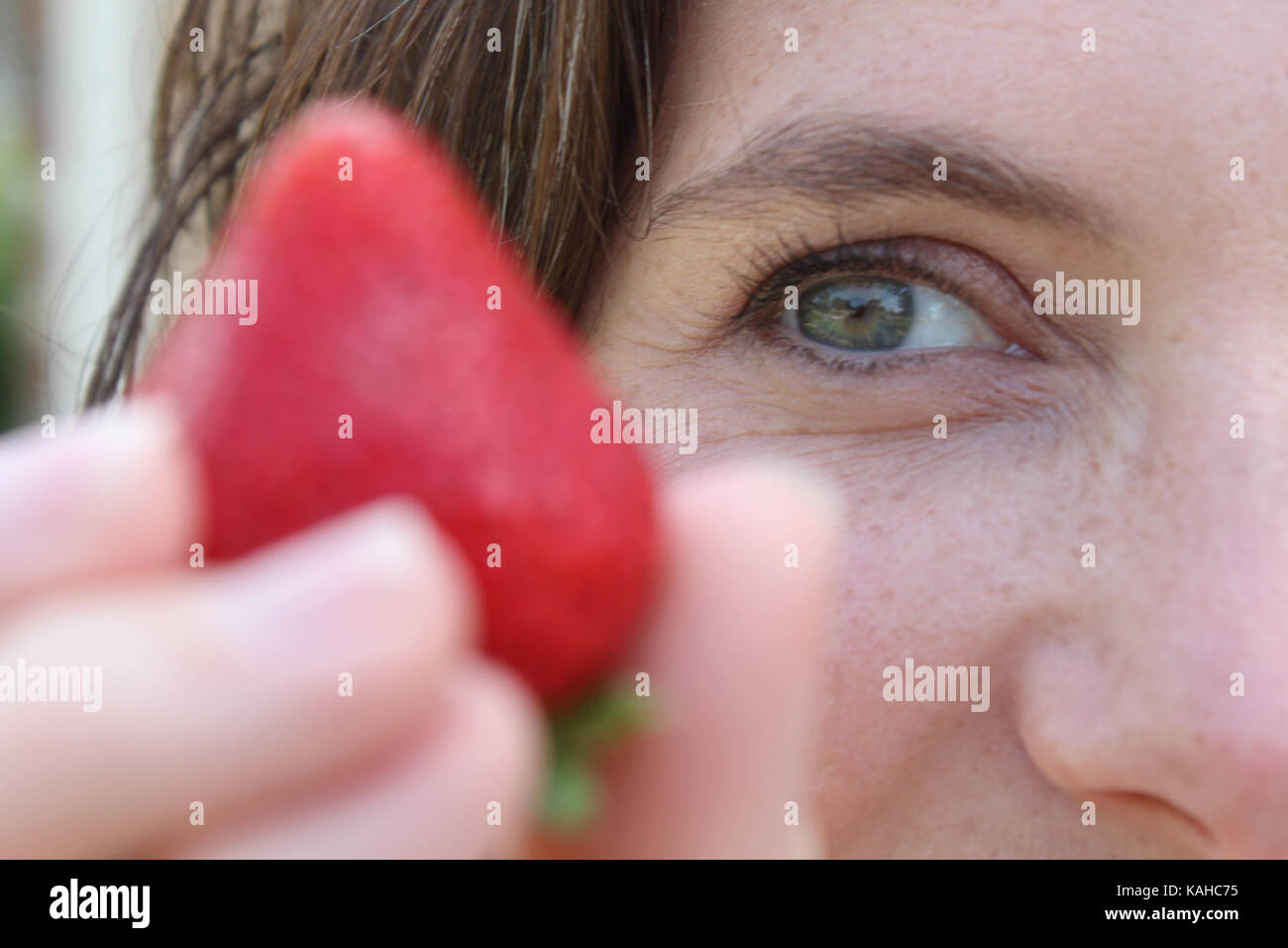 Woman with Strawberry Stock Photo - Alamy